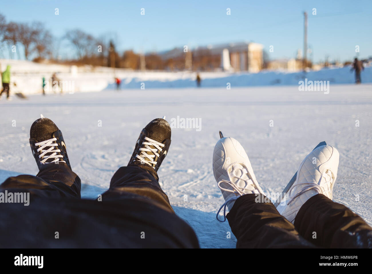 Male and Femal Feet in Ice Skates Have a Rest On Ice Rink Surface ...