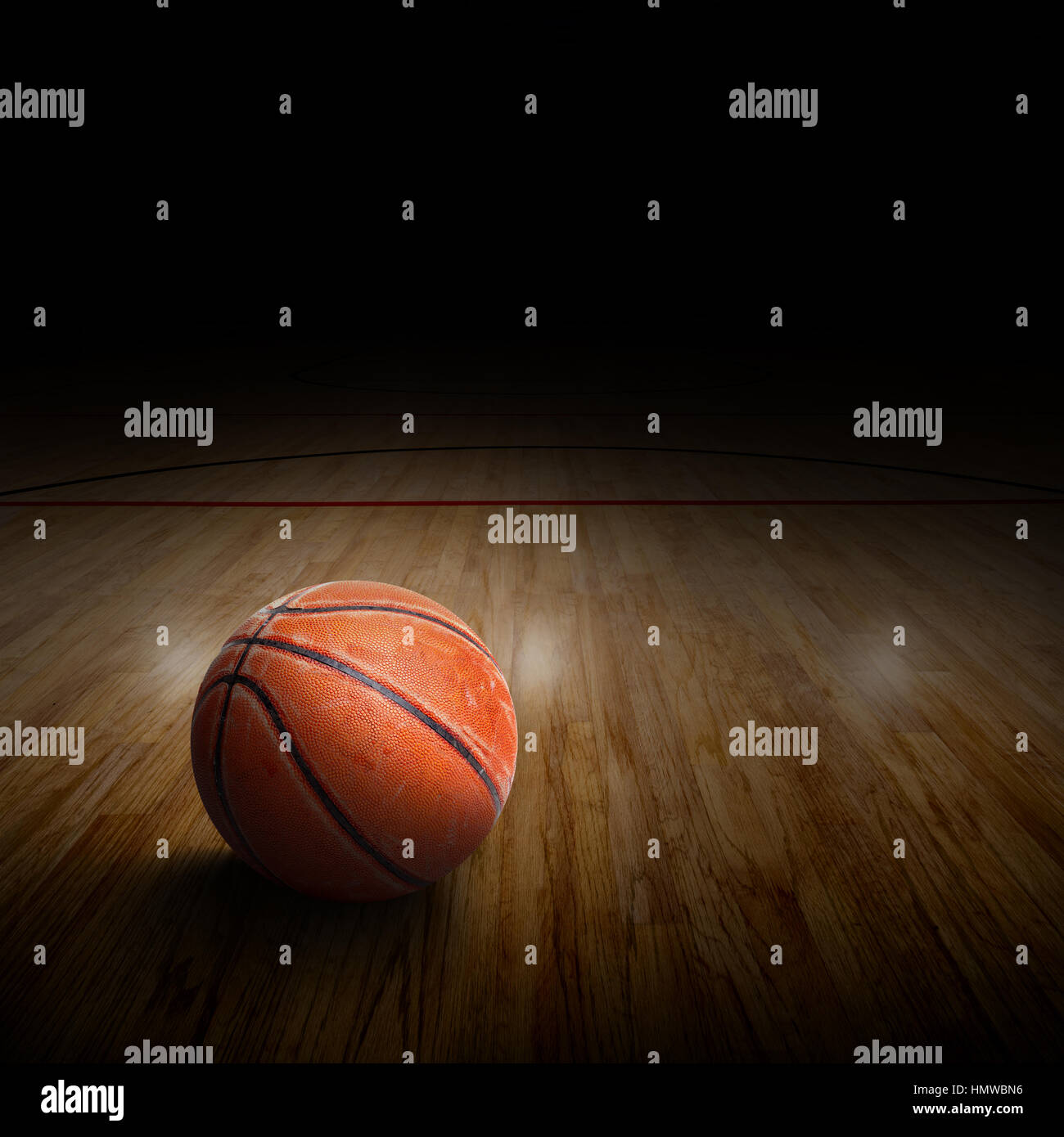 Basketball arena with ball on court and special lighting effect. Copy ...