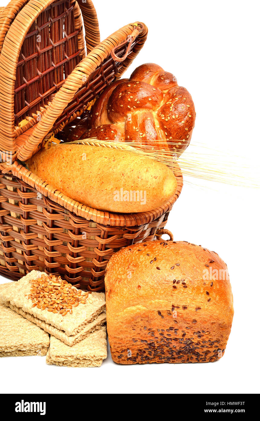 Fresh bread, dry loaf and wheat ears in the basket isolated on white ...