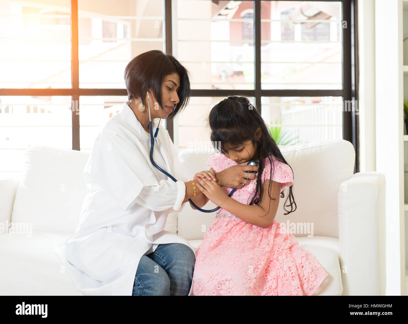 indian female doctor treating young patient Stock Photo - Alamy