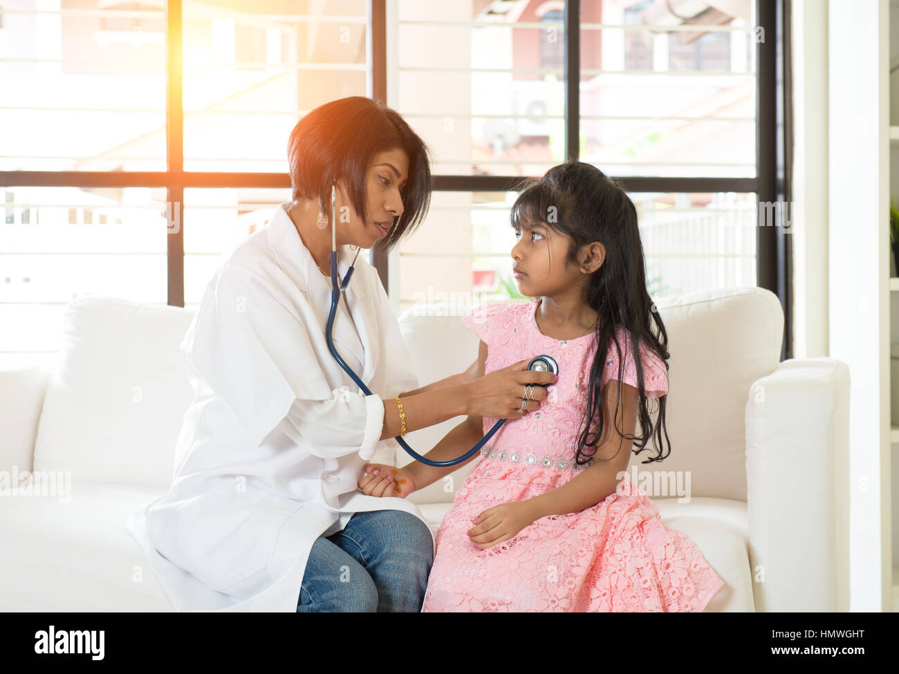 indian female doctor treating young girl patient Stock Photo - Alamy