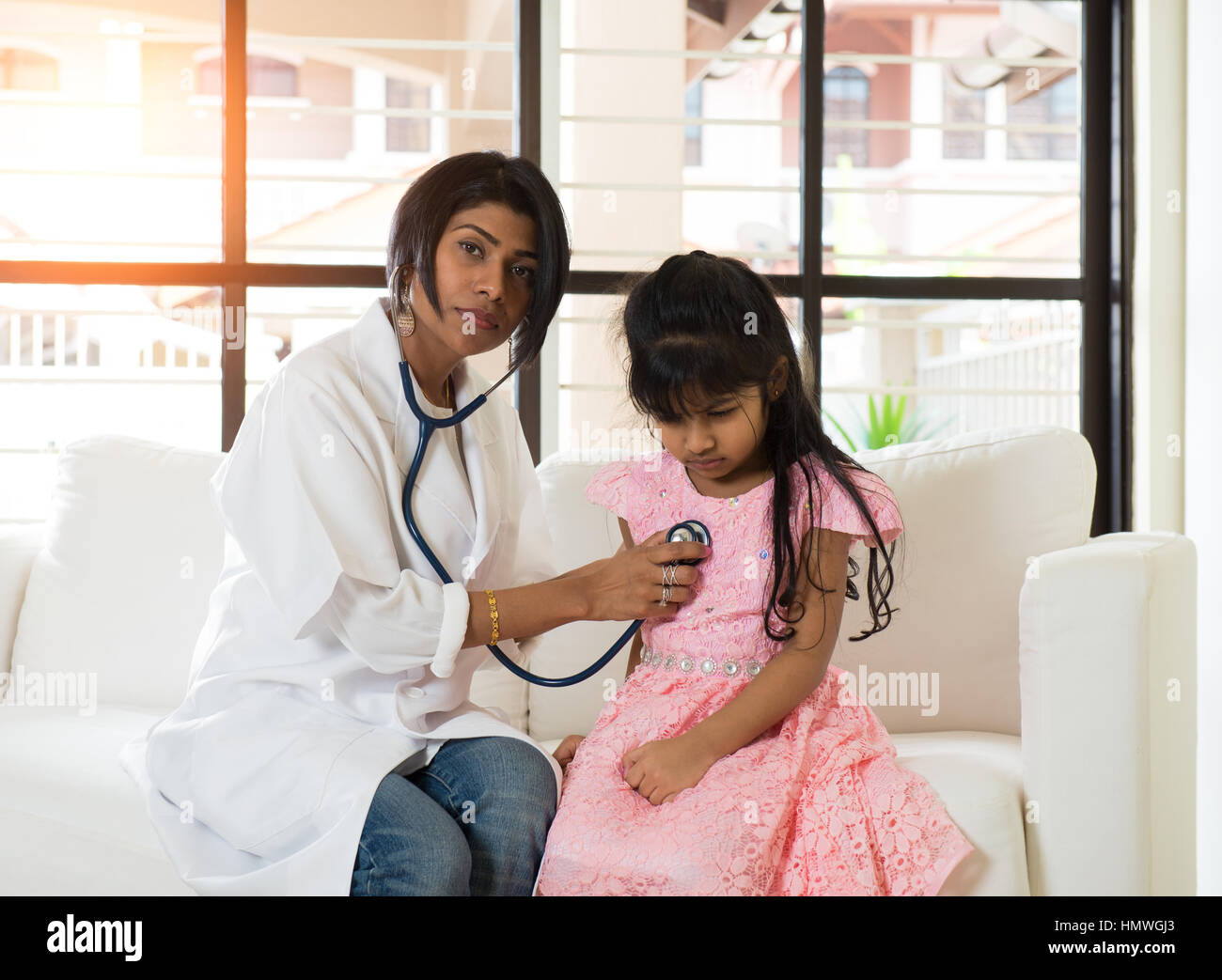 indian female doctor treating young girl patient Stock Photo - Alamy