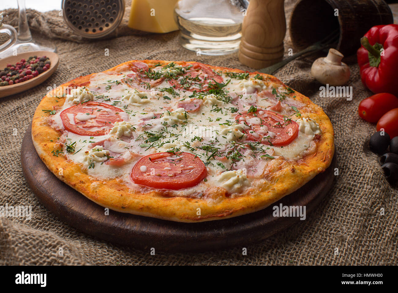 Pizza with ham cheese and tomatoes Stock Photo - Alamy