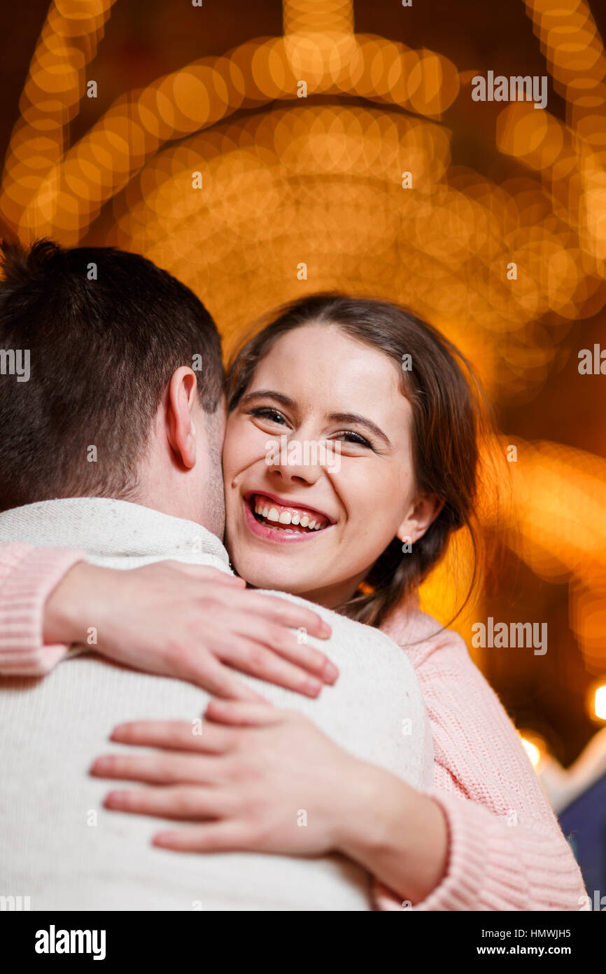 Beautiful couple hugging at hall with garlands Stock Photo - Alamy