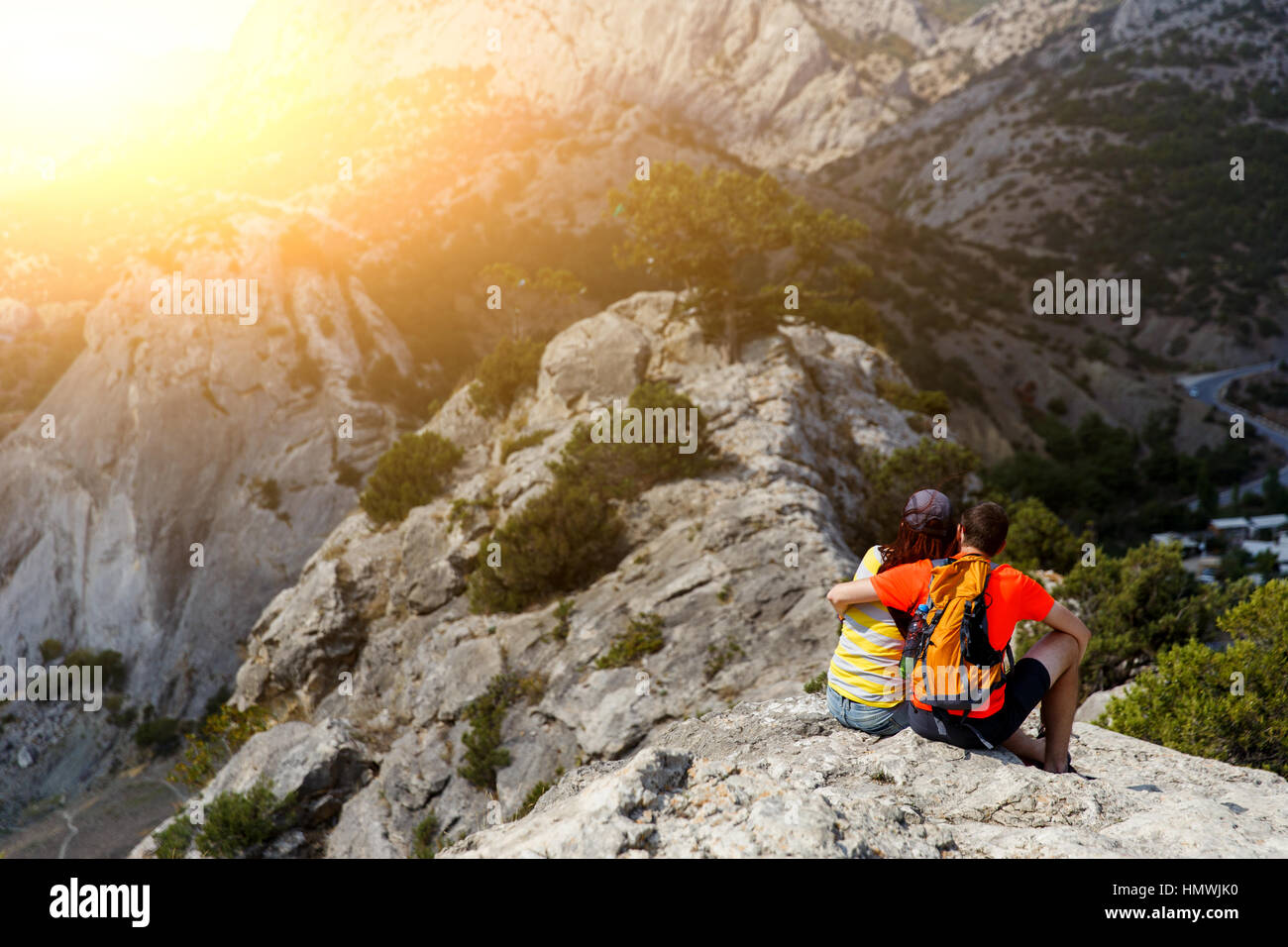 Romantic picture of love couple sitting on mound Stock Photo - Alamy