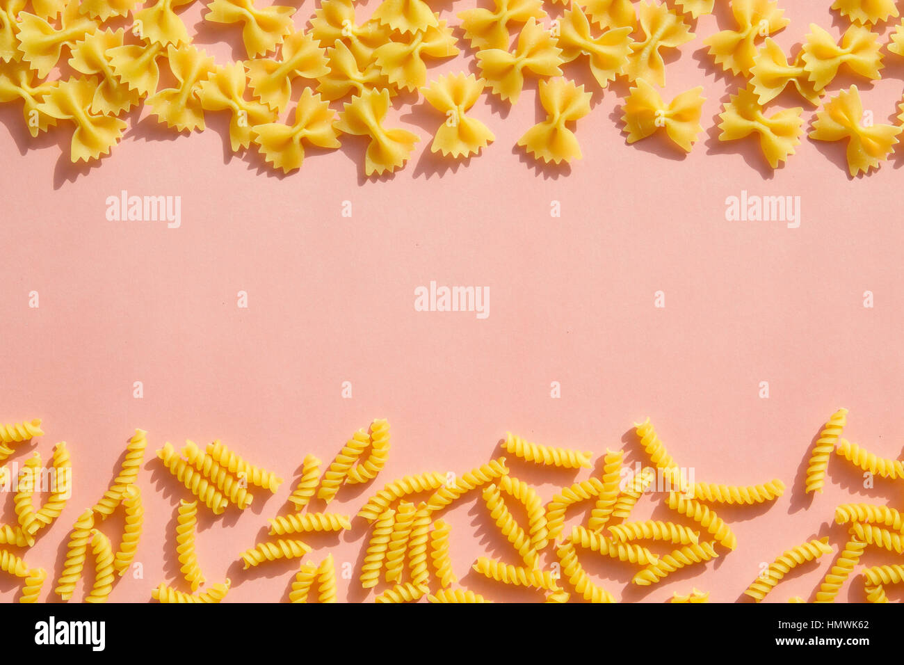 Pasta bow and spiral shape on pink background with space for text Stock ...