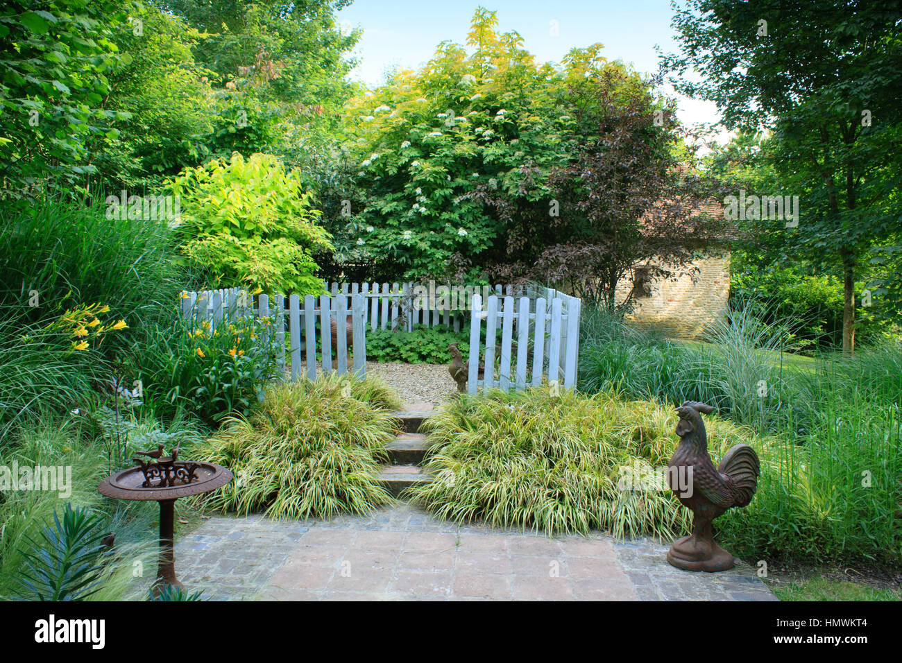 Enclosure for iron hens and stairs bordered with Acorus gramineus 'Ogon ...