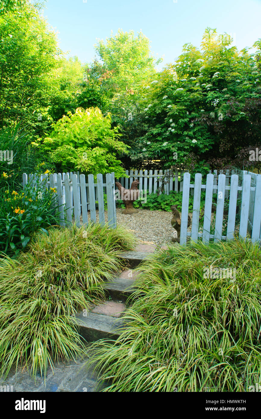 Enclosure for iron hens and stairs bordered with Acorus gramineus 'Ogon ...