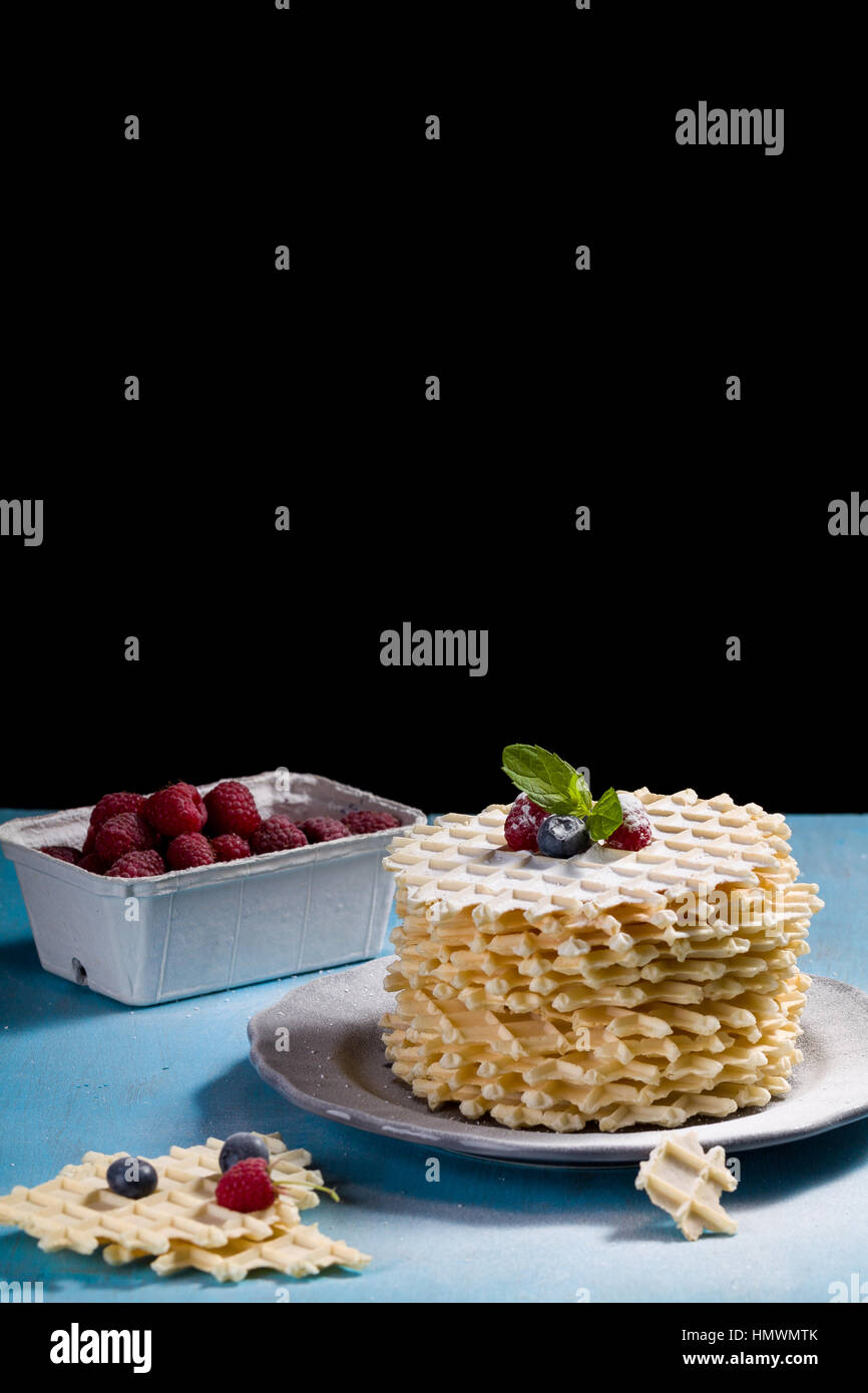 Belgian lush round waffles with fresh raspberries, twigs and leaves ...