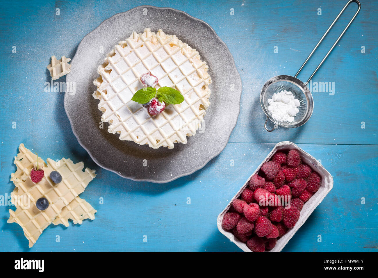 Belgian lush round waffles with fresh raspberries, twigs and leaves ...