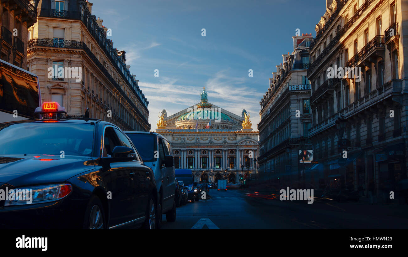 Traffic cars in front of Opera, Paris. The Palais Garnier is a 1,979 ...