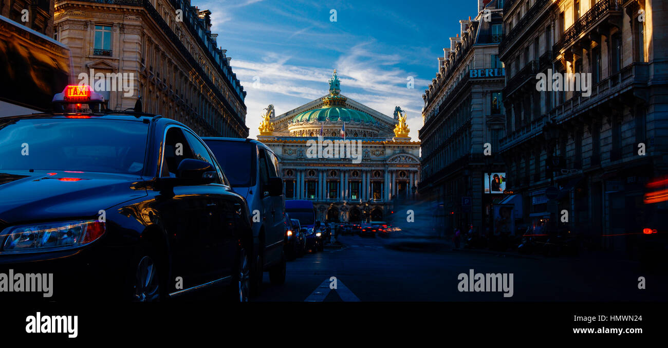 Traffic cars in front of Opera, Paris. The Palais Garnier is a 1,979 ...