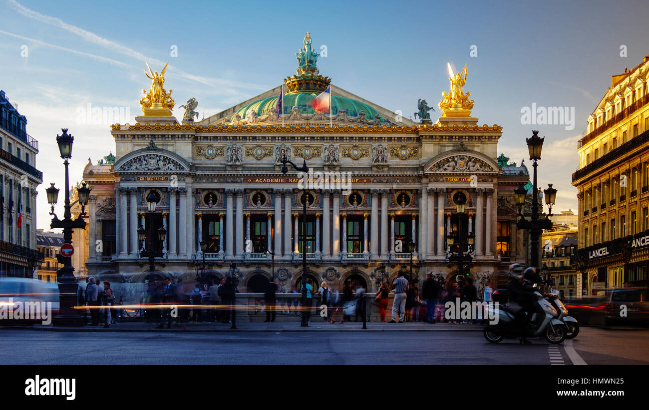 Traffic cars in front of Opera, Paris. The Palais Garnier is a 1,979 ...