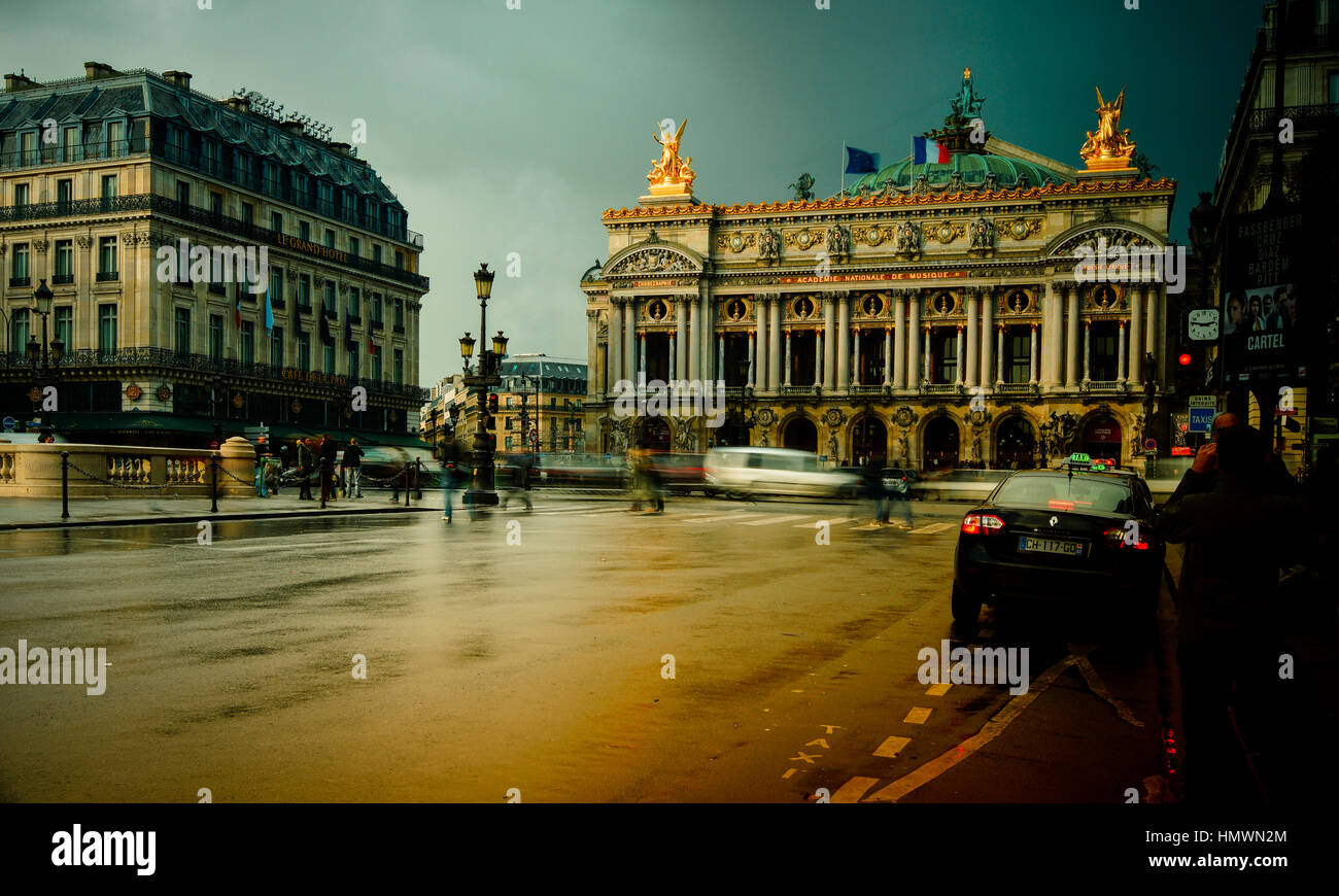 Traffic cars in front of Opera, Paris. The Palais Garnier is a 1,979 ...