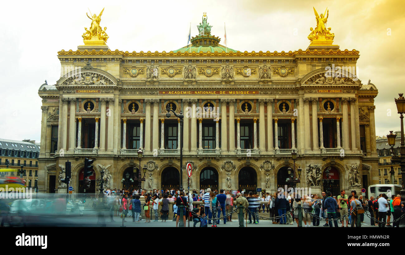 Traffic cars in front of Opera, Paris. The Palais Garnier is a 1,979 ...