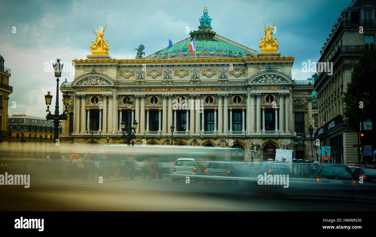 Traffic cars in front of Opera, Paris. The Palais Garnier is a 1,979 ...