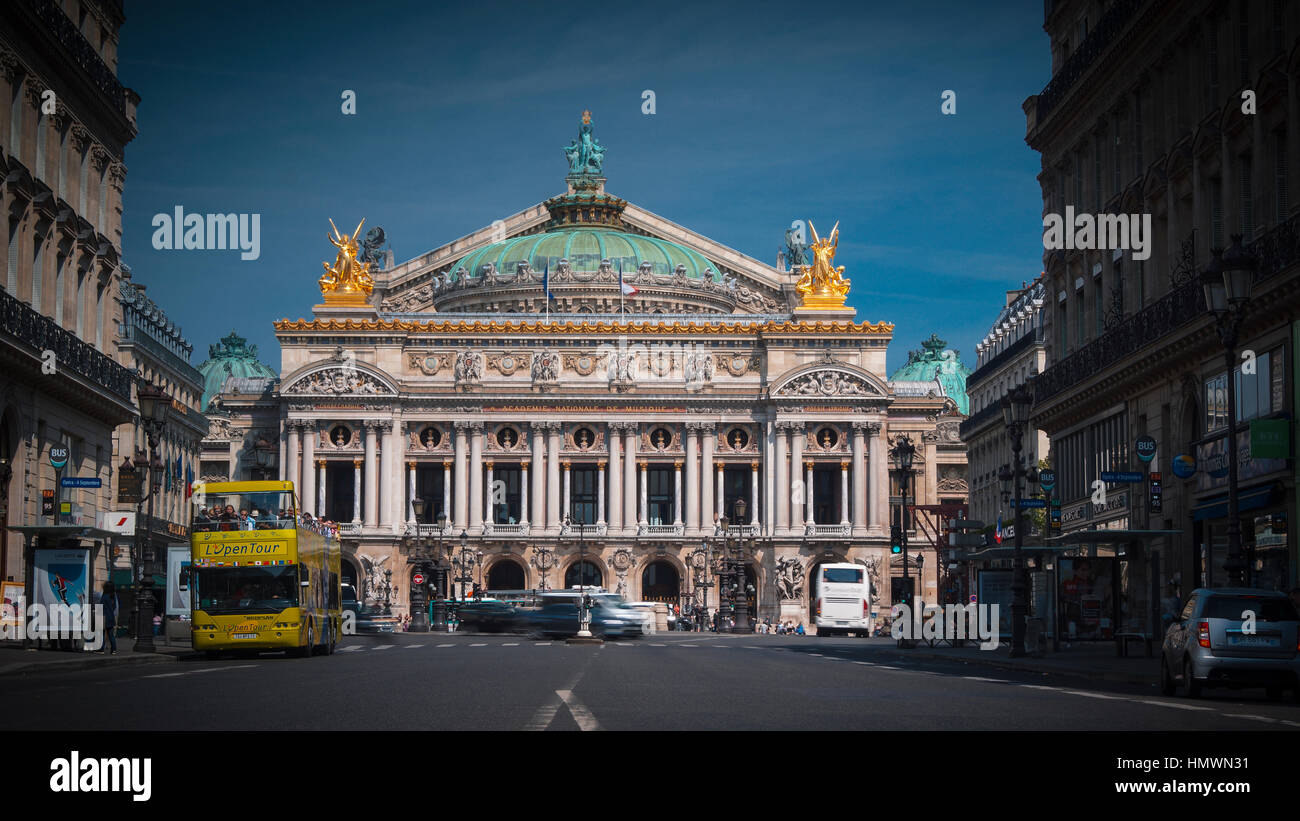 Traffic cars in front of Opera, Paris. The Palais Garnier is a 1,979 ...