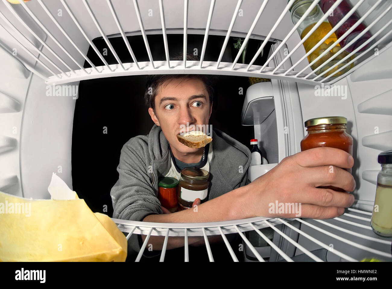 man takes food from the refrigerator Stock Photo - Alamy