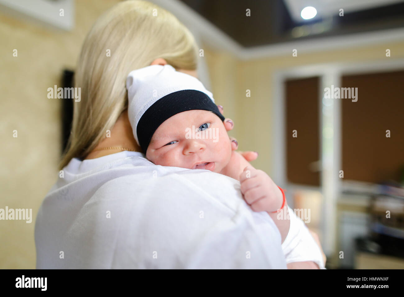 Young female lulls and sings songs for child, gently hugging and ...