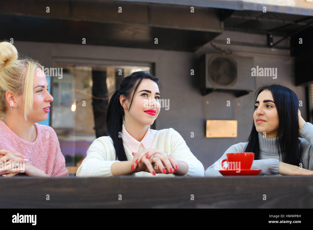 Concept female friendship, meeting, lunch. Three beautiful women ...