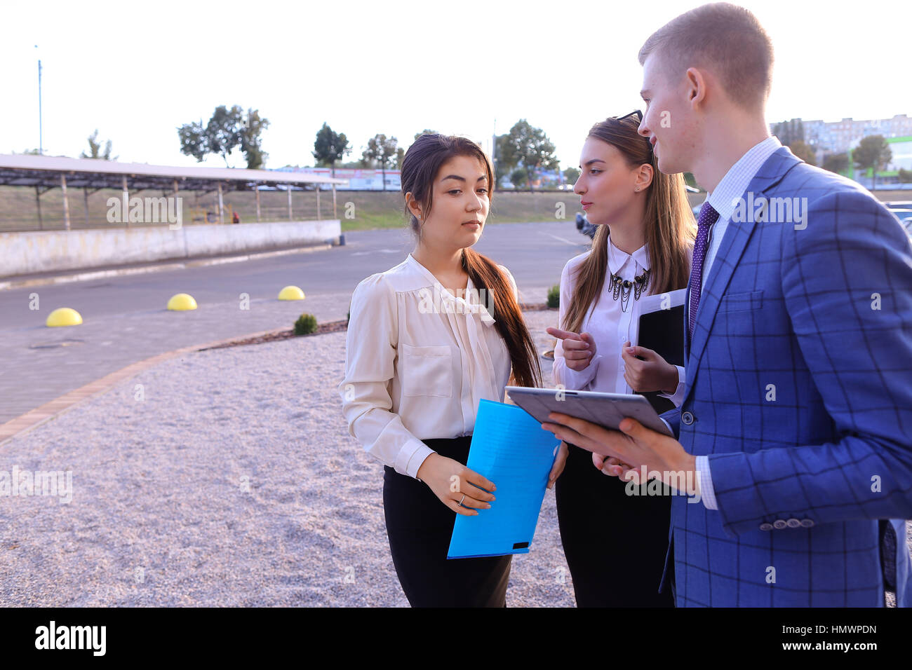 Two young charming clever girl and handsome masculine guy, successful ...