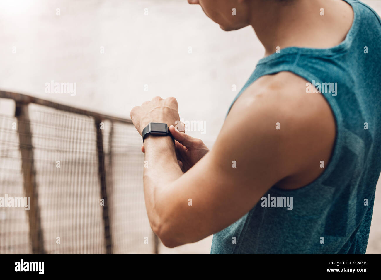 Close up shot of young man outdoors using a smartwatch to monitor his ...