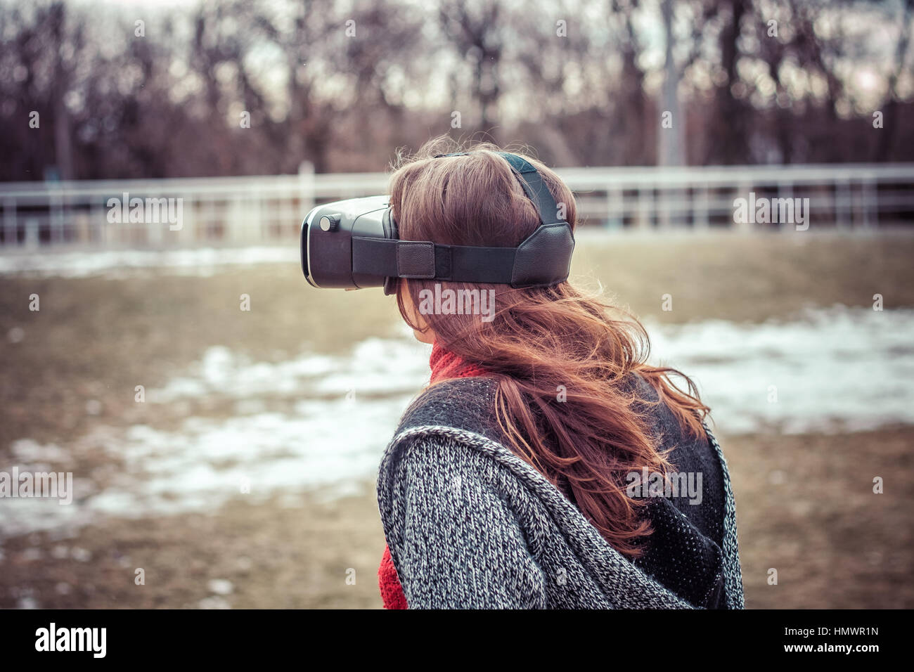 beautiful young girl with virtual reality VR headset on the street ...