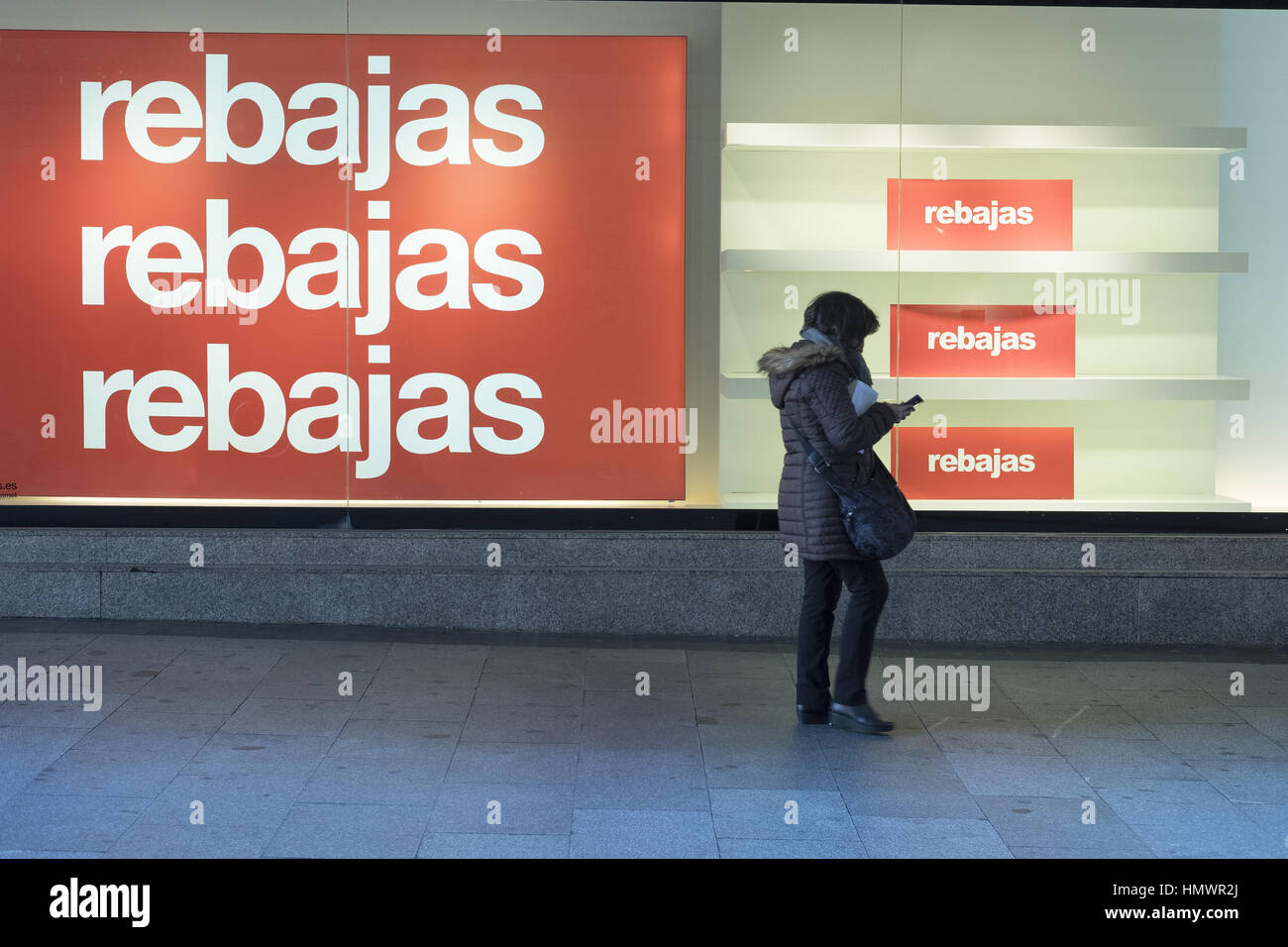 A shop front sign announces discounts on the first day of the winter ...