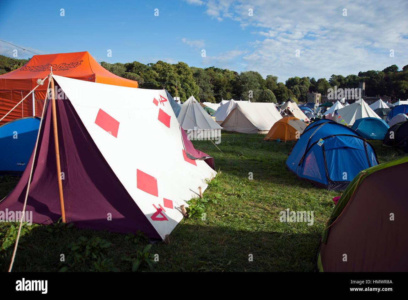 A tent made to look like a playing card amongst tents in the campsite ...
