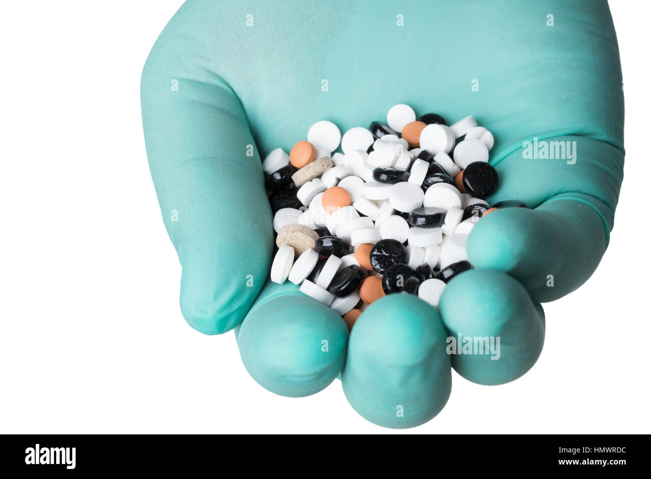 pill in a hand isolated on white background Stock Photo - Alamy