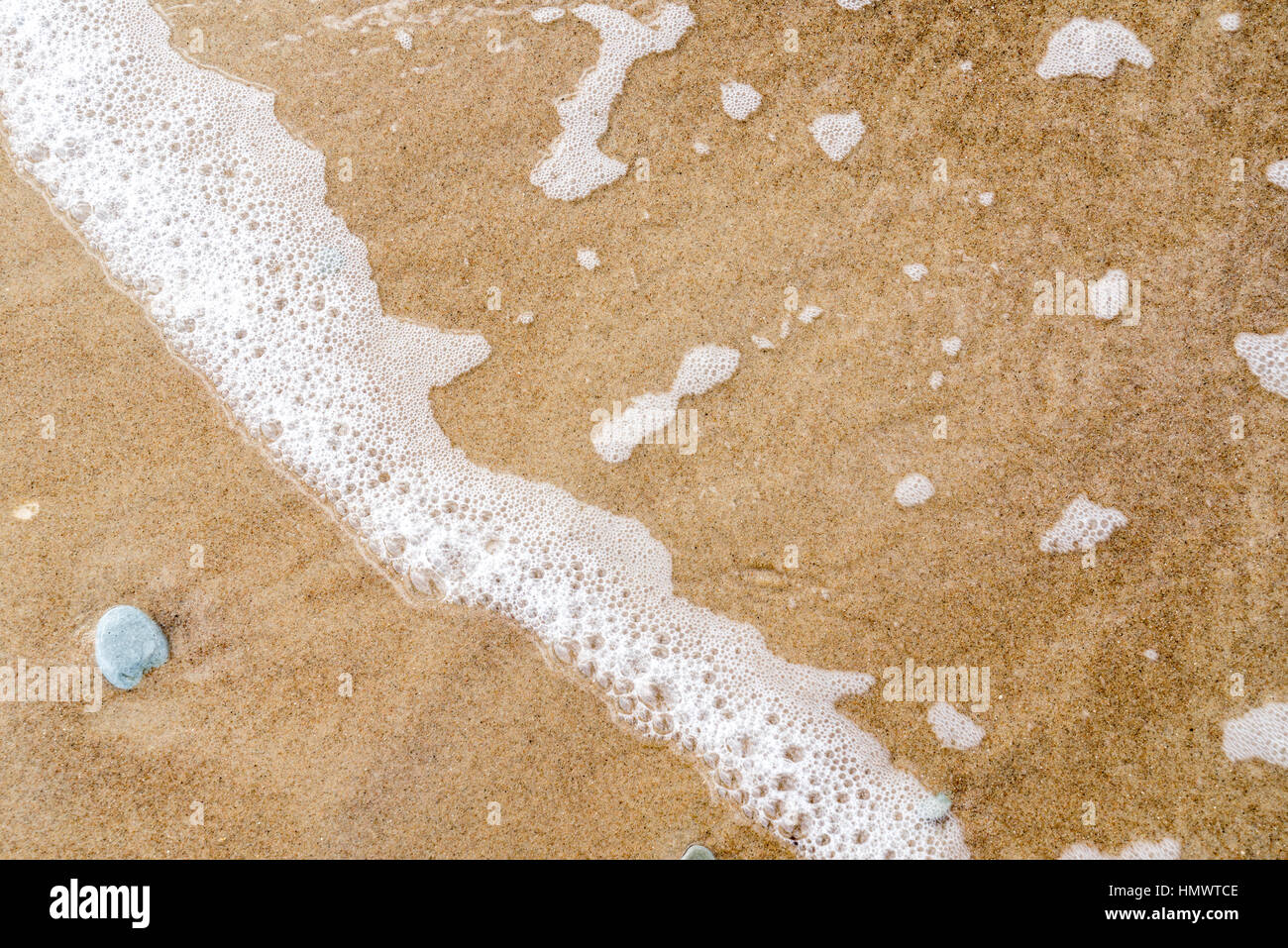 water waves rushing in sand Stock Photo - Alamy