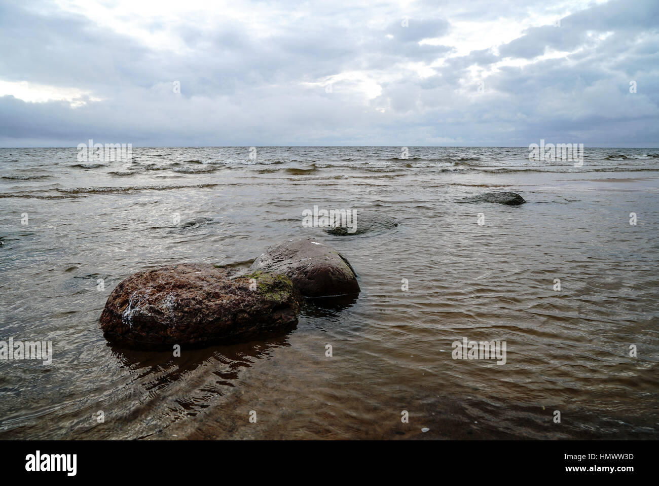 wet rocks on the beach in water Stock Photo - Alamy