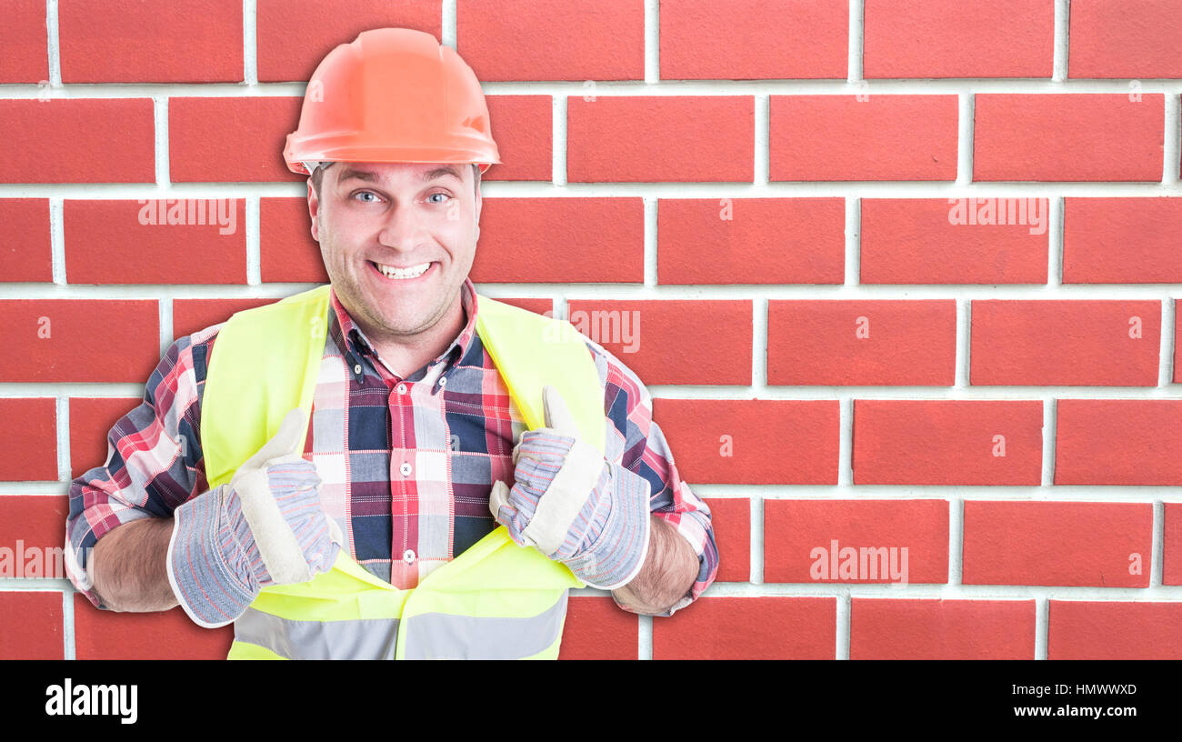Happy builder smiling and acting like superman while showing his chest ...