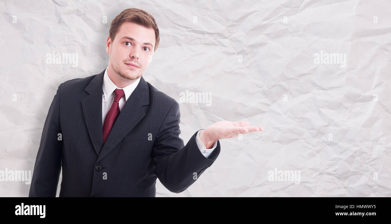 Portrait of male executive introducing or presenting something and ...