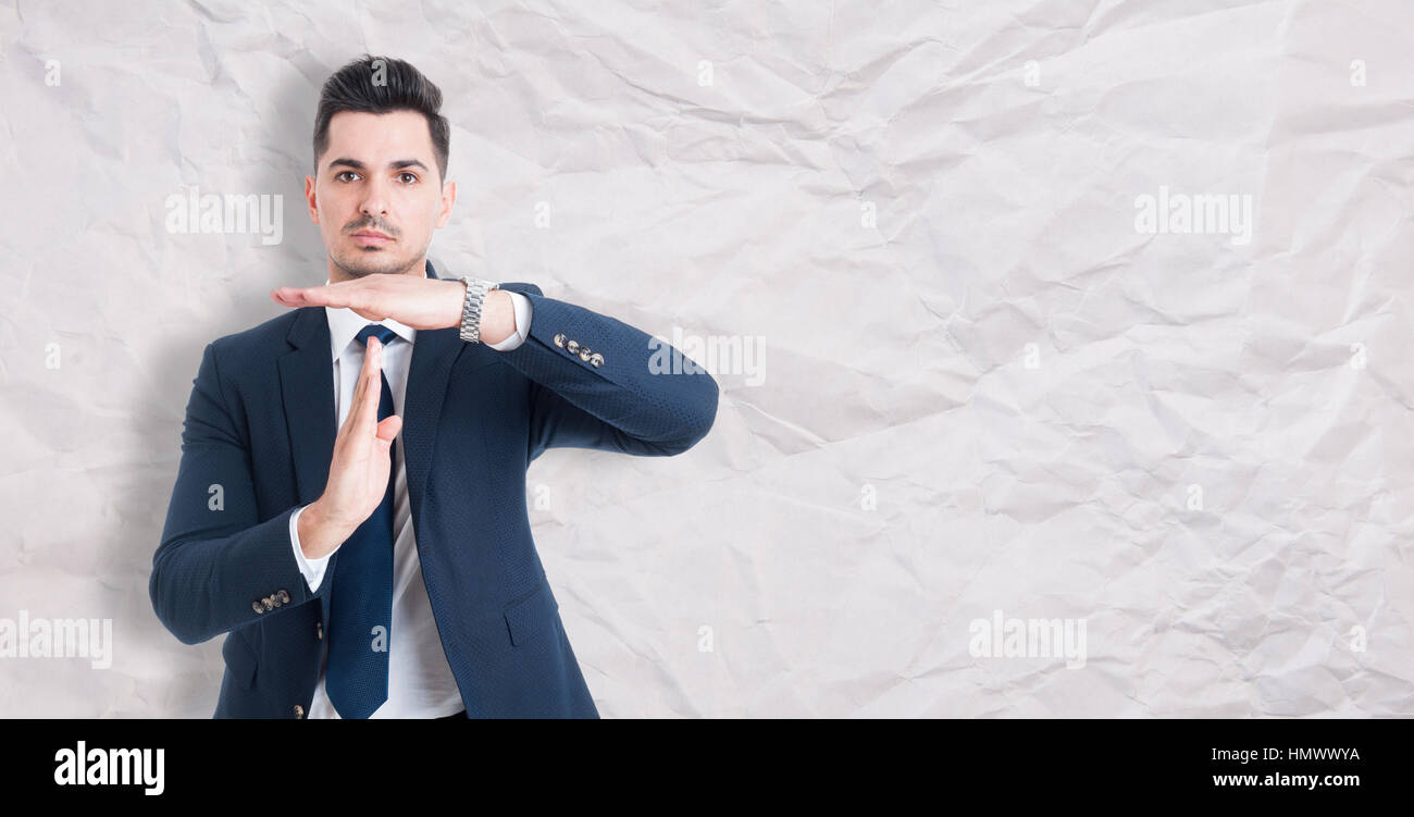 Serious businessman showing time out sign with hands as break concept ...