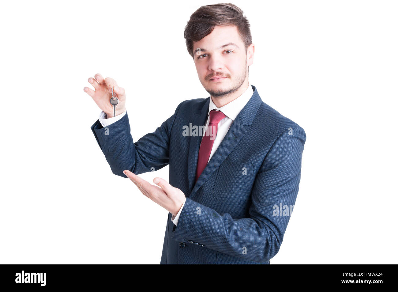 Real estate agent wearing suit showing keying isolated on white ...
