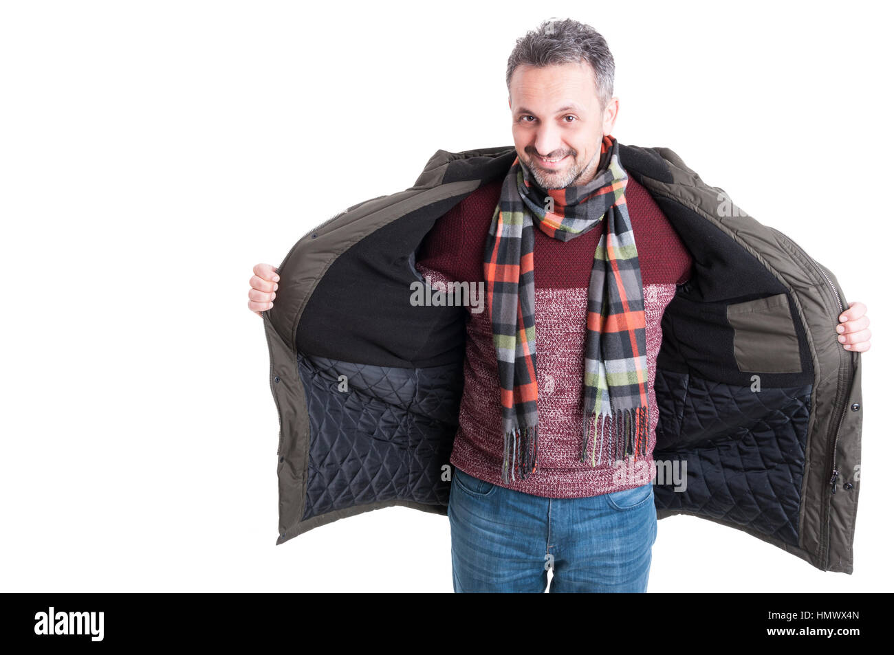 Man showing winter layers under his jacket isolated on white background ...