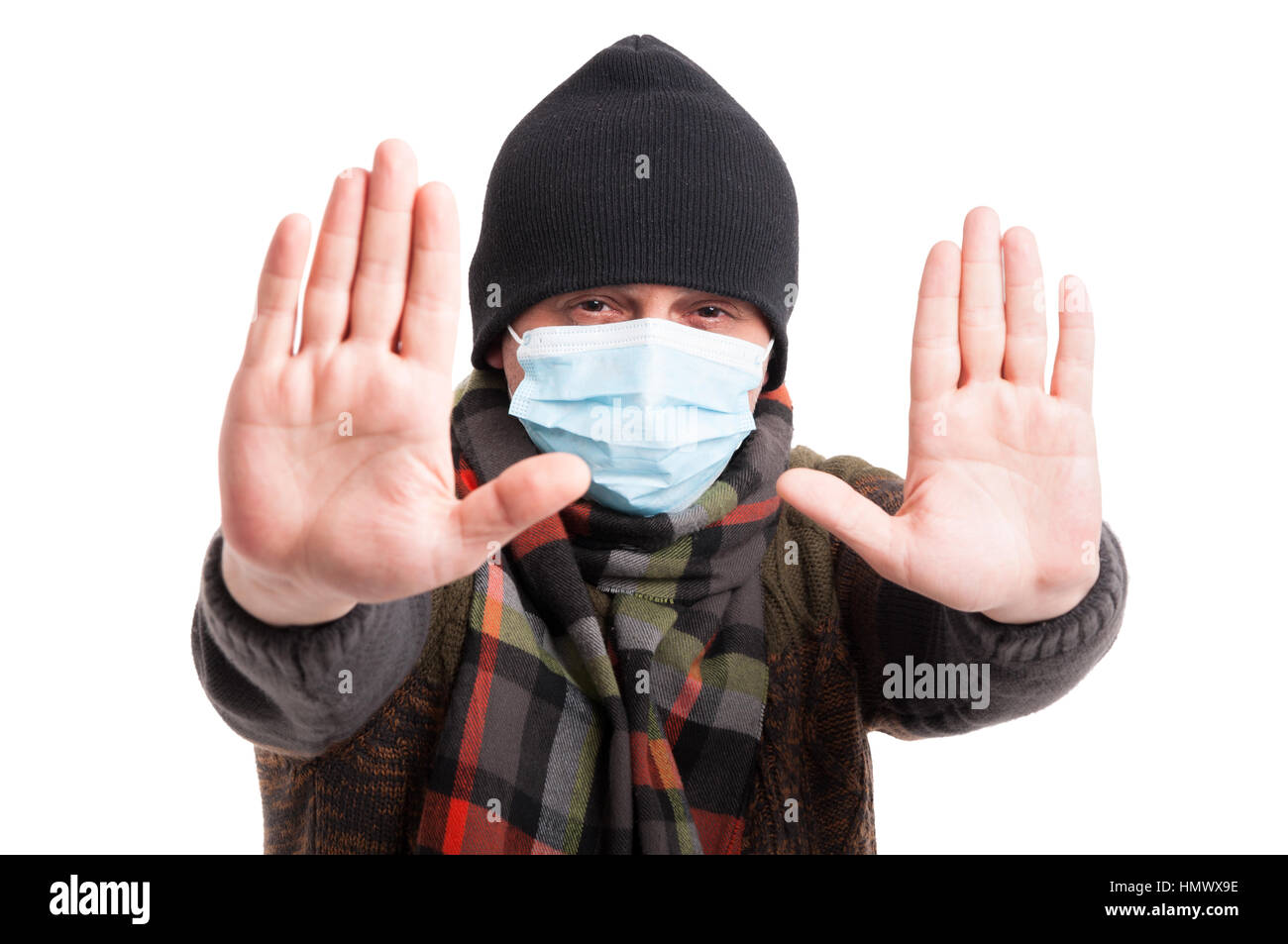 Sick male with sterile mask on his face doing stop gesture with both ...