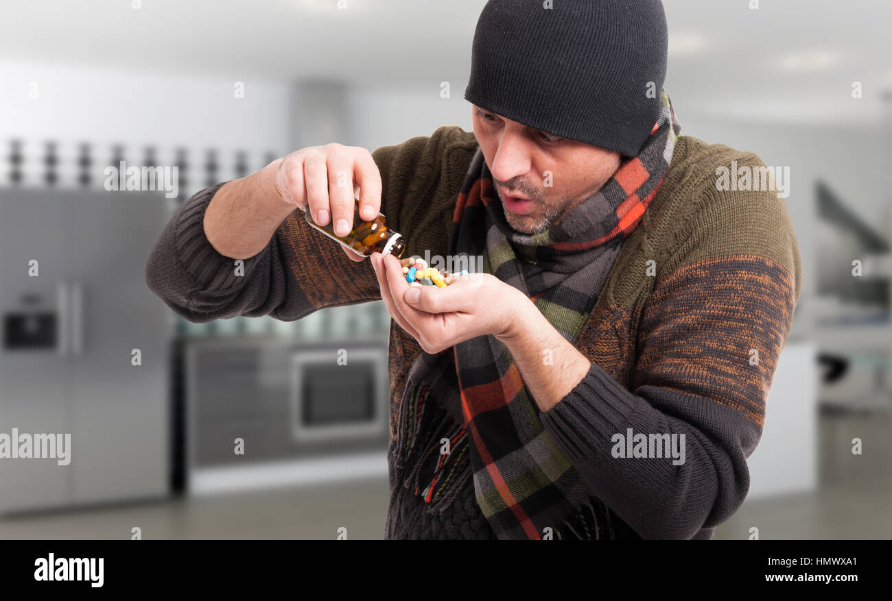 Sick man taking too many pills as drugs or medication abuse concept ...