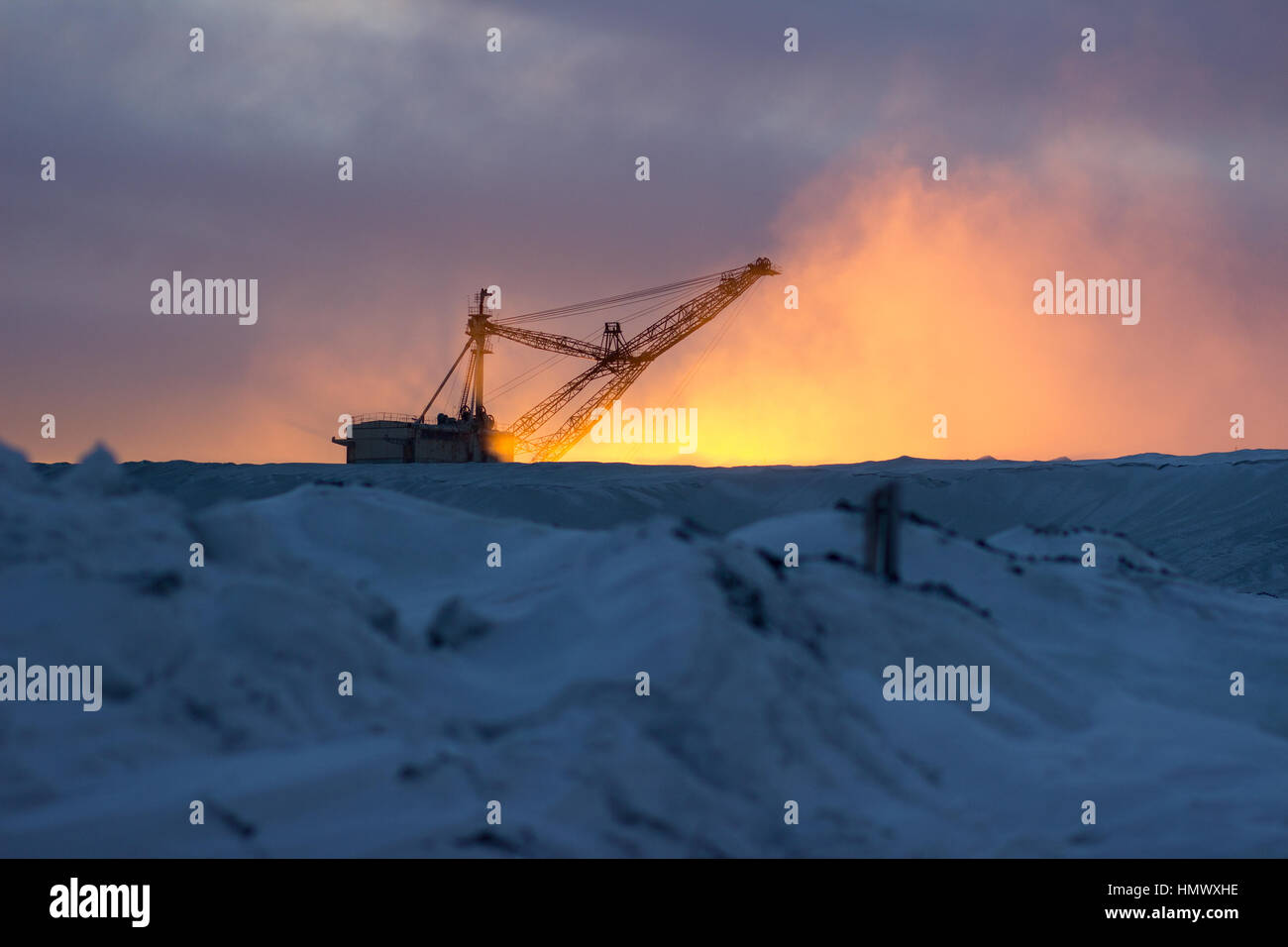 Heavy Mining Excavator in a quarry at sunset Stock Photo - Alamy