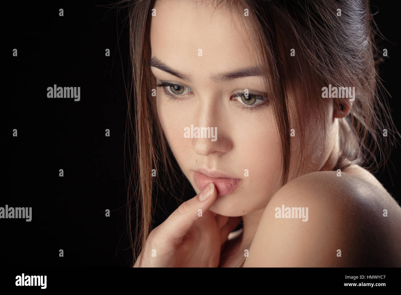 beautiful sad girl portrait on black background Stock Photo - Alamy