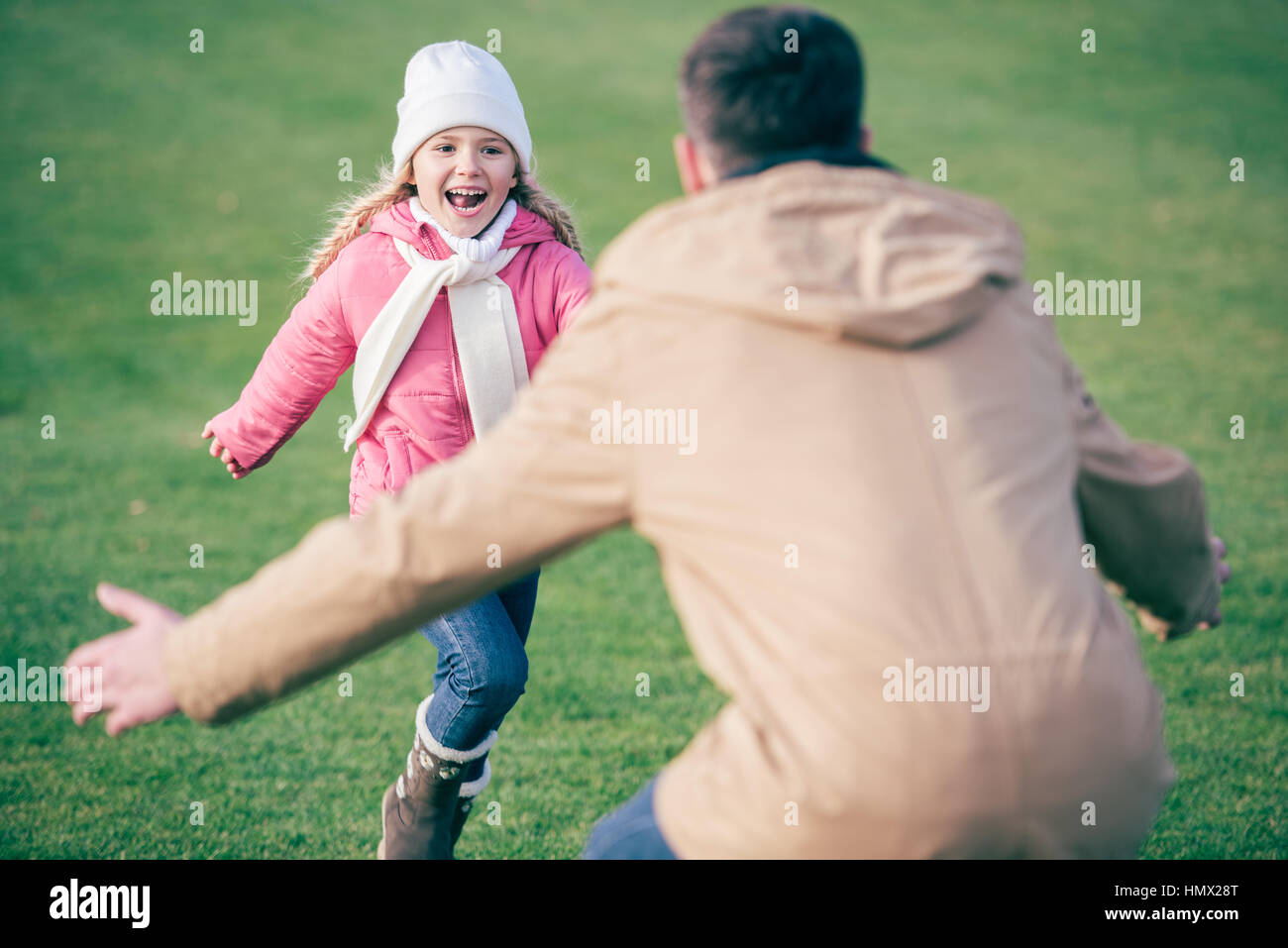 Adorable smiling girl running to father Stock Photo - Alamy