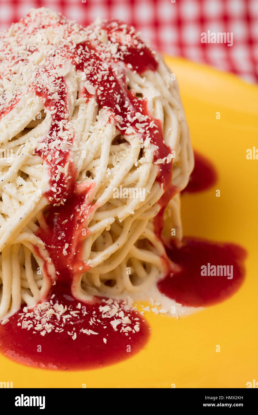 Homemade spaghetti ice cream with red strawberry sauce and white ...