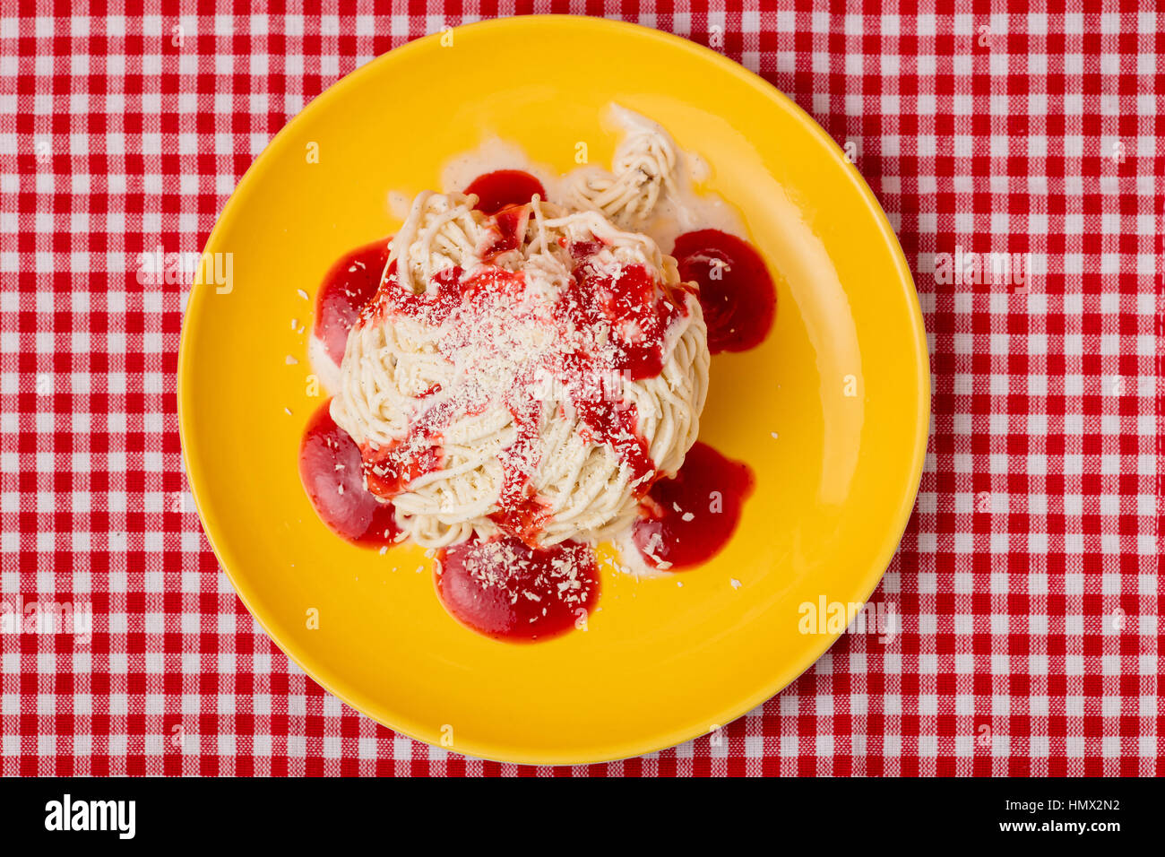 Top view of homemade spaghetti ice cream with red strawberry sauce and ...