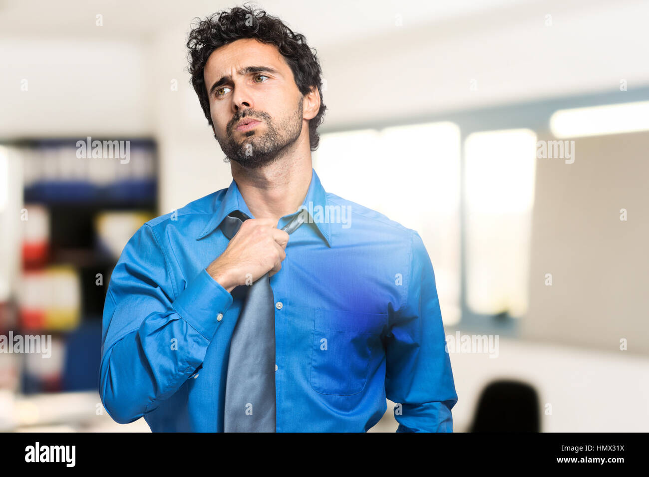 Sweating businessman due to hot climate Stock Photo - Alamy