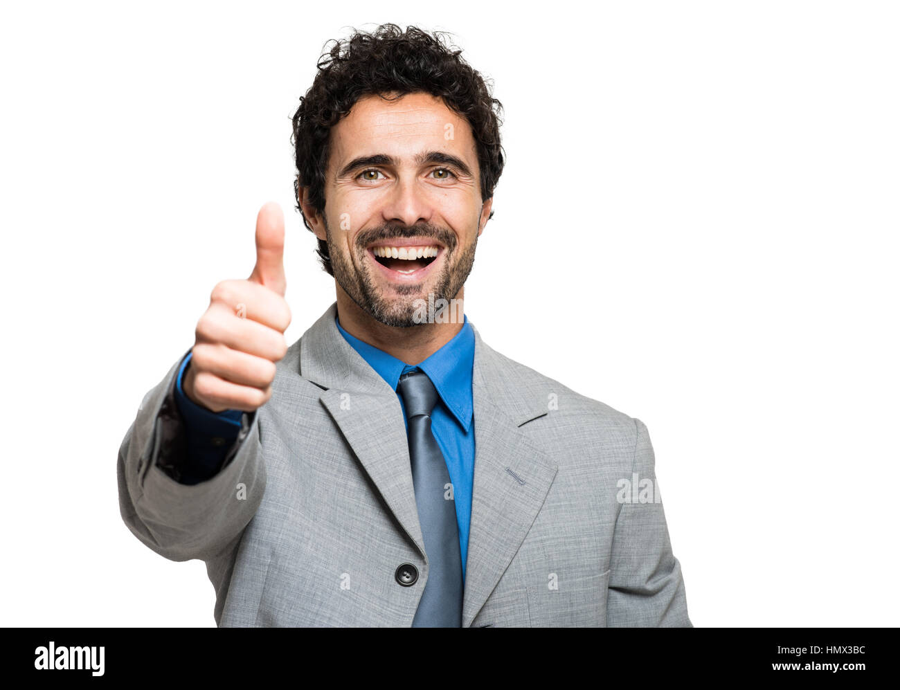 Portrait of a smiling businessman giving thumbs up Stock Photo - Alamy