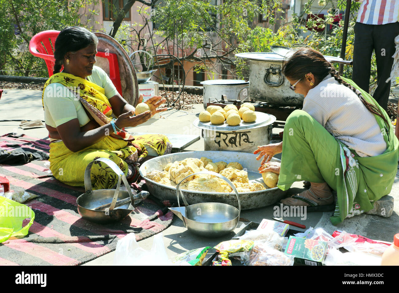 People are cooking traditional Indian food bafle and gatta curry on a ...