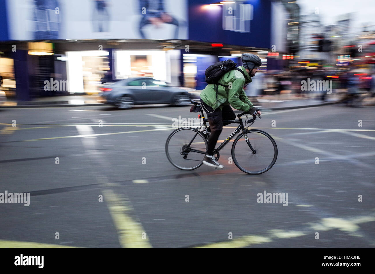 A commuter rides a bike through Central London Stock Photo - Alamy