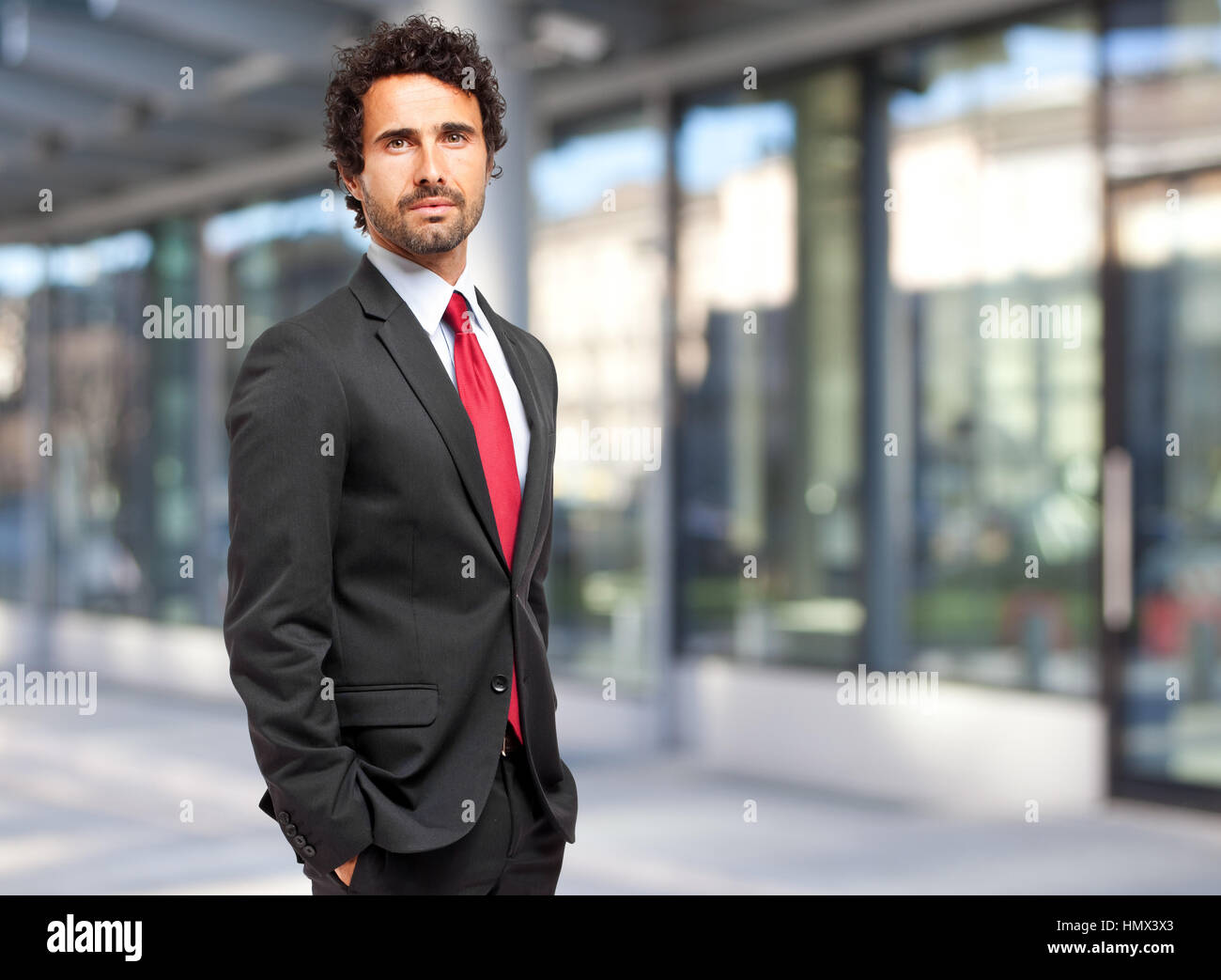 Handsome manager against blurry background Stock Photo - Alamy