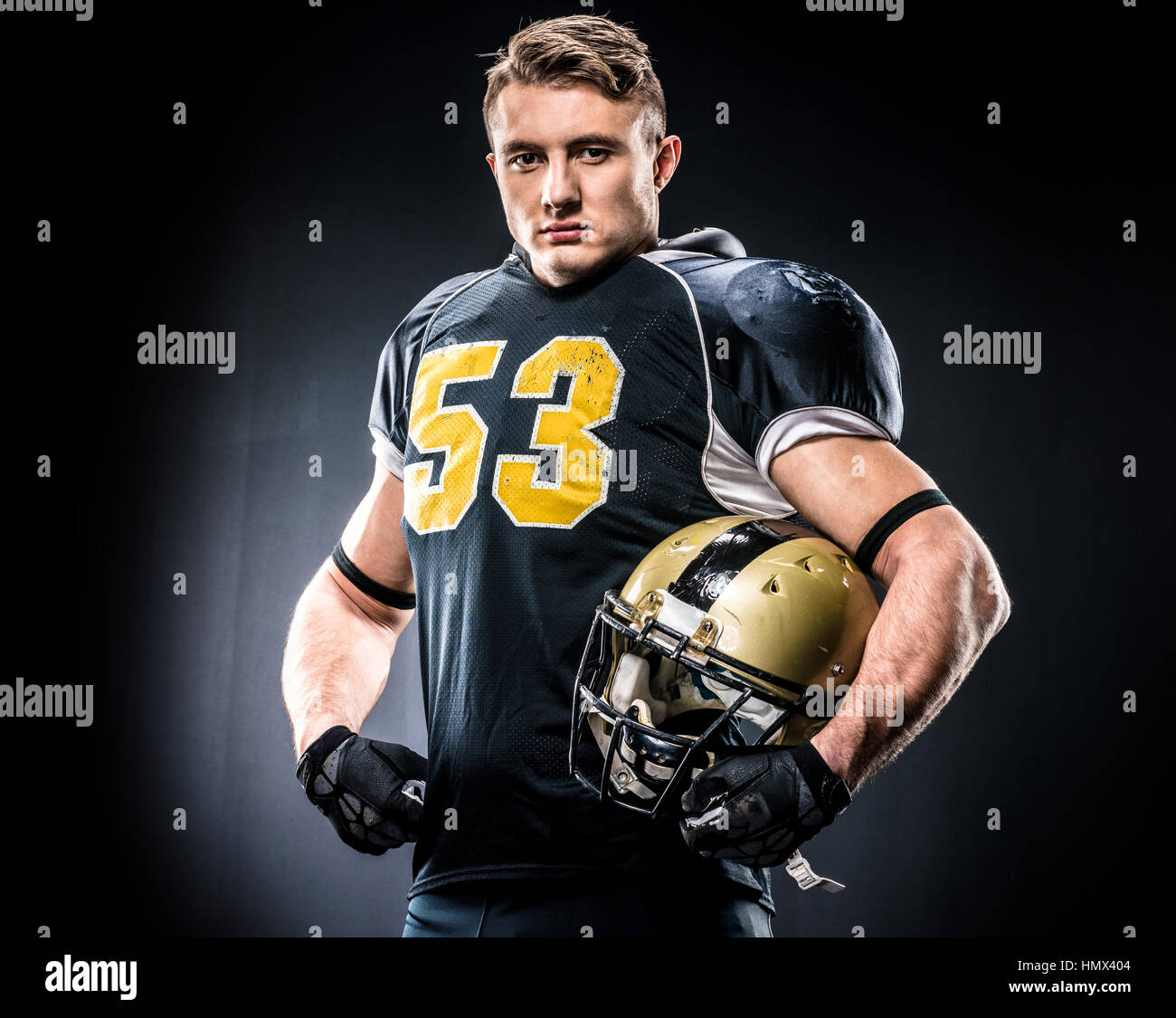 Football player holding helmet football hi-res stock photography and ...